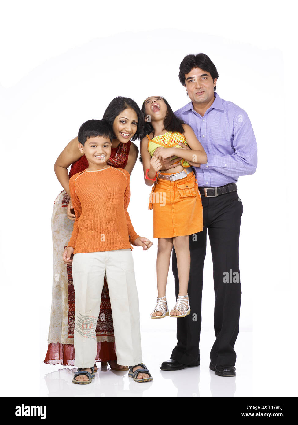 PORTRAIT OF AN INDIAN FAMILY OF FOUR DRESSED IN CASUAL CLOTHES Stock ...