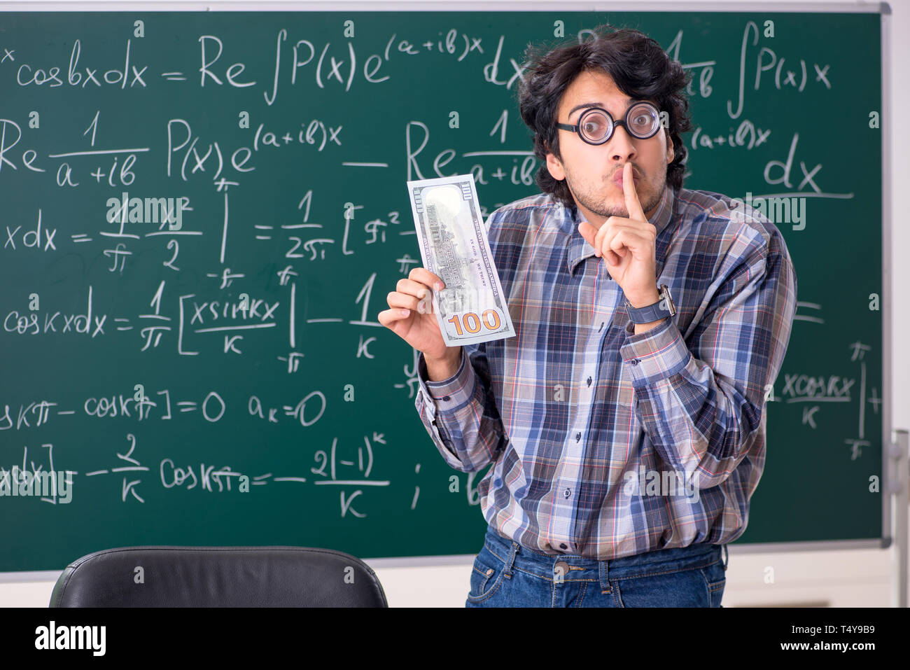 Funny male math teacher in the classroom Stock Photo - Alamy