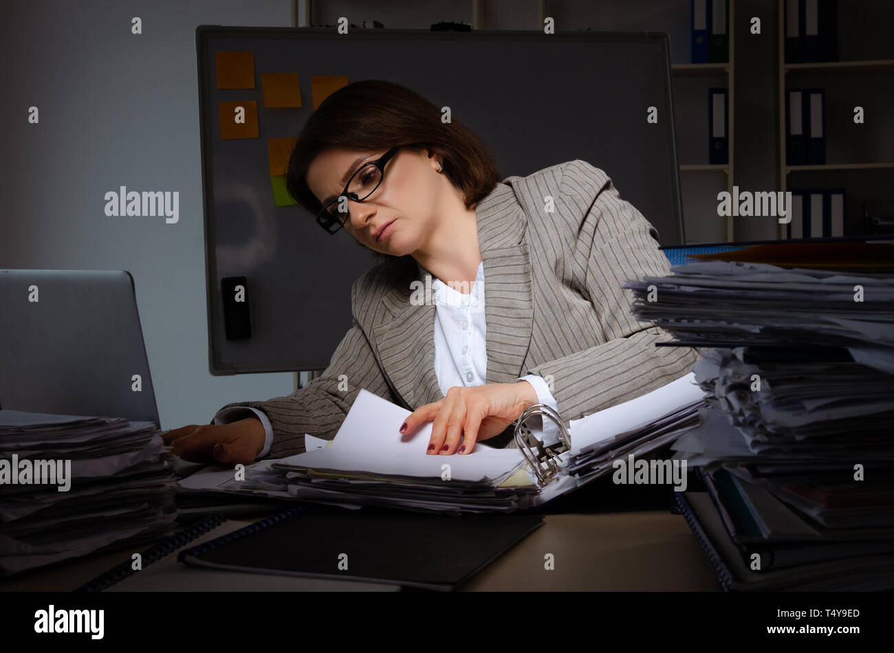 Female employee suffering from excessive work Stock Photo - Alamy