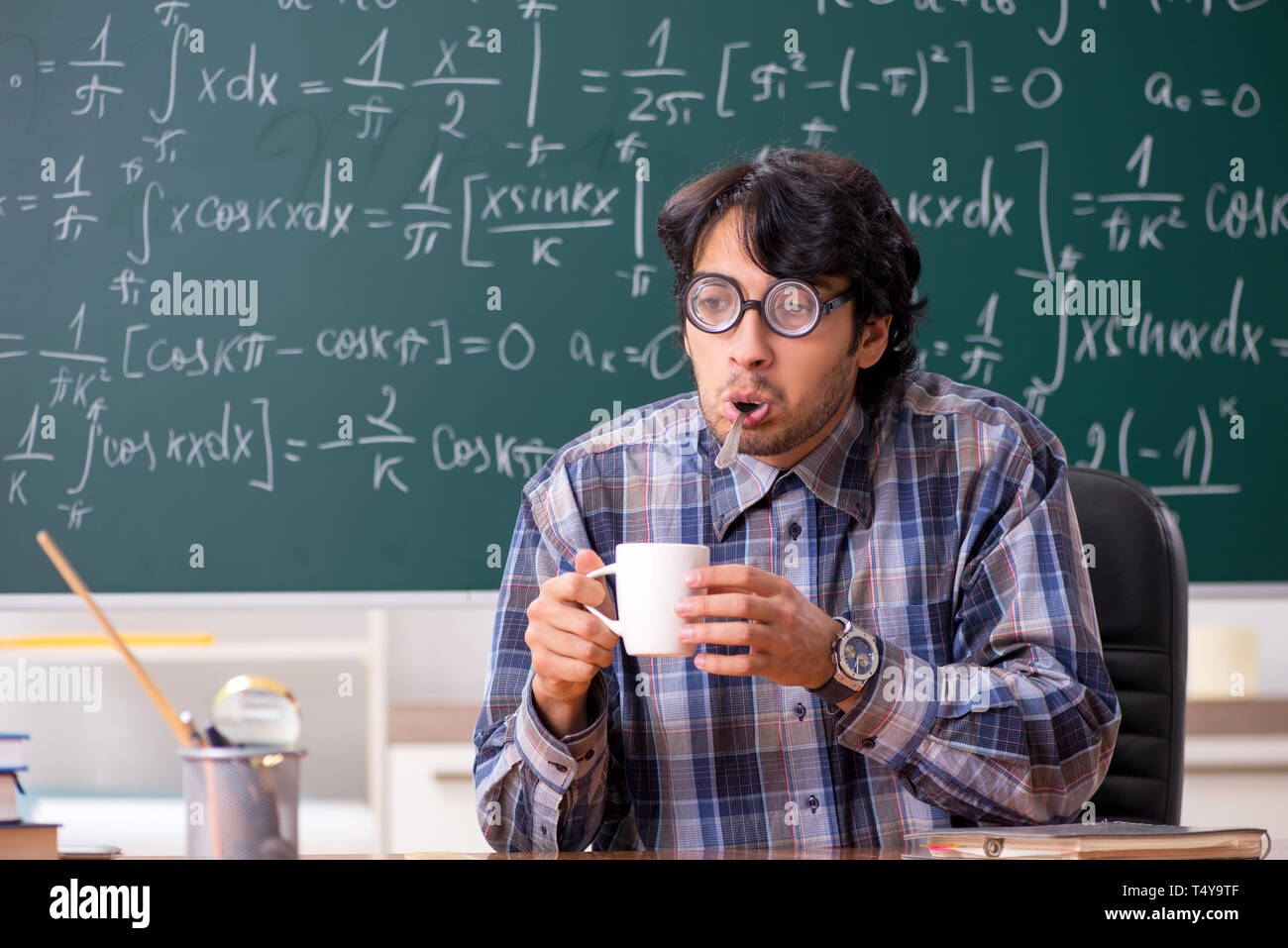 Funny male math teacher in the classroom Stock Photo - Alamy