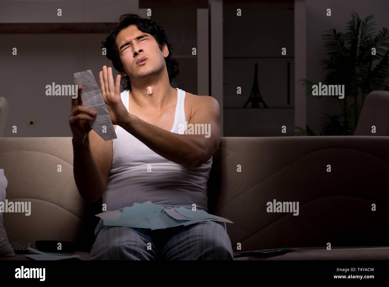 Young man calculating expences hi-res stock photography and images - Alamy