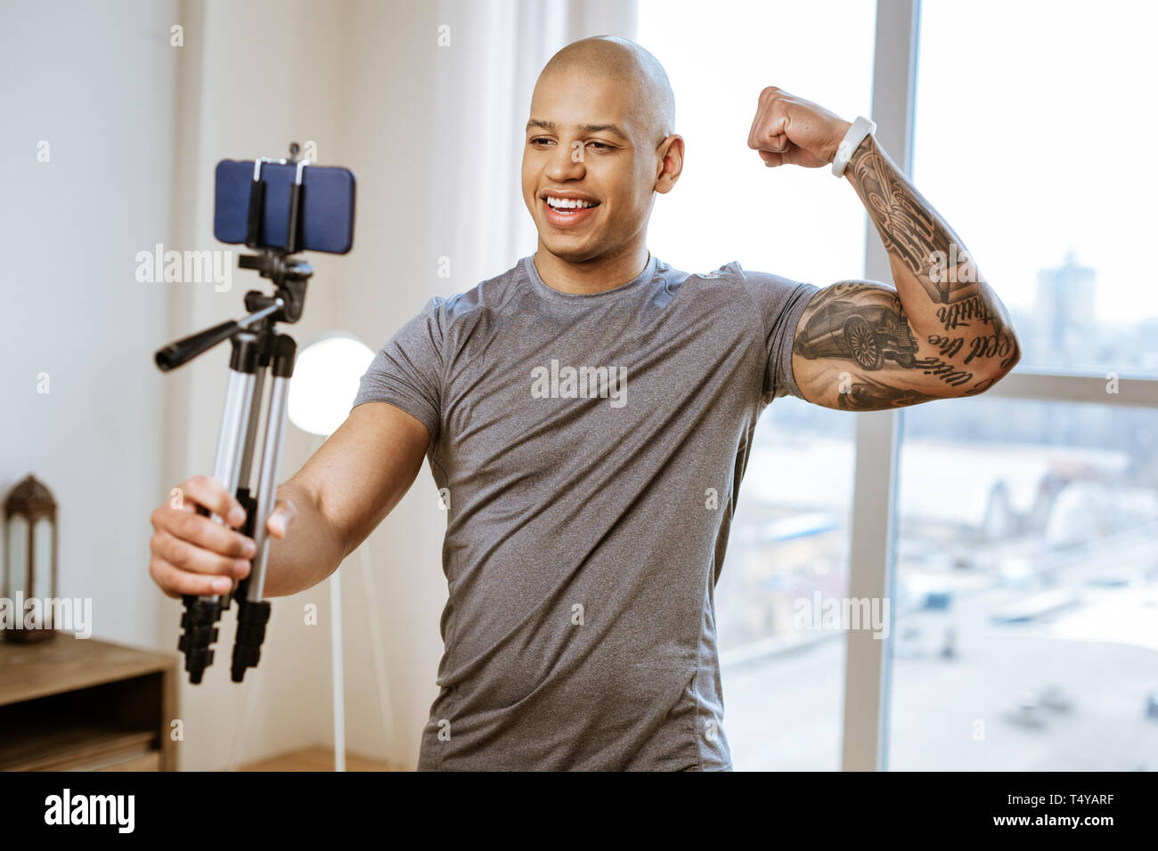 Bodybuilder with tattoo on hand wearing white smart watch Stock Photo ...