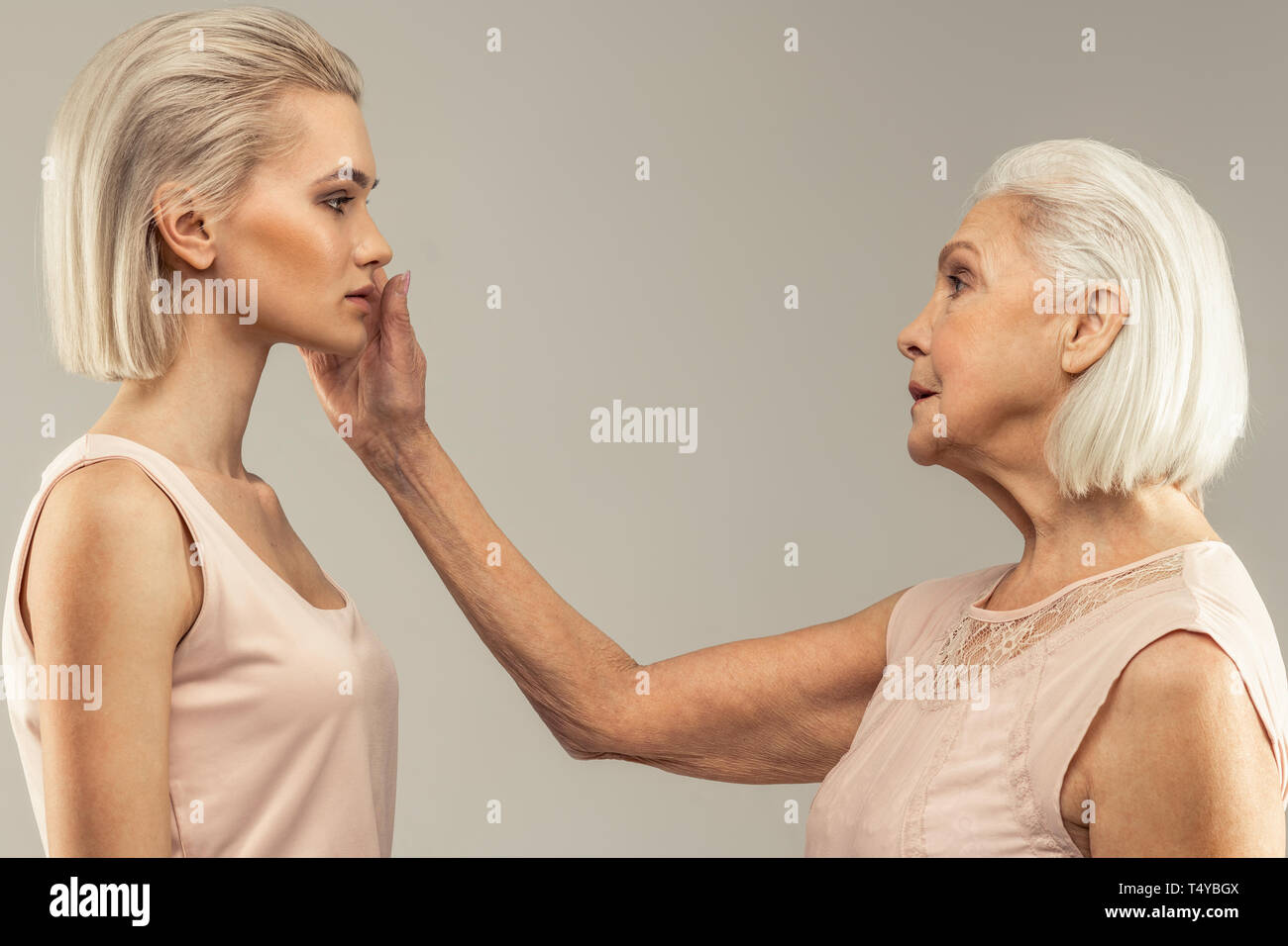 Serious sad woman touching her daughters cheek Stock Photo - Alamy