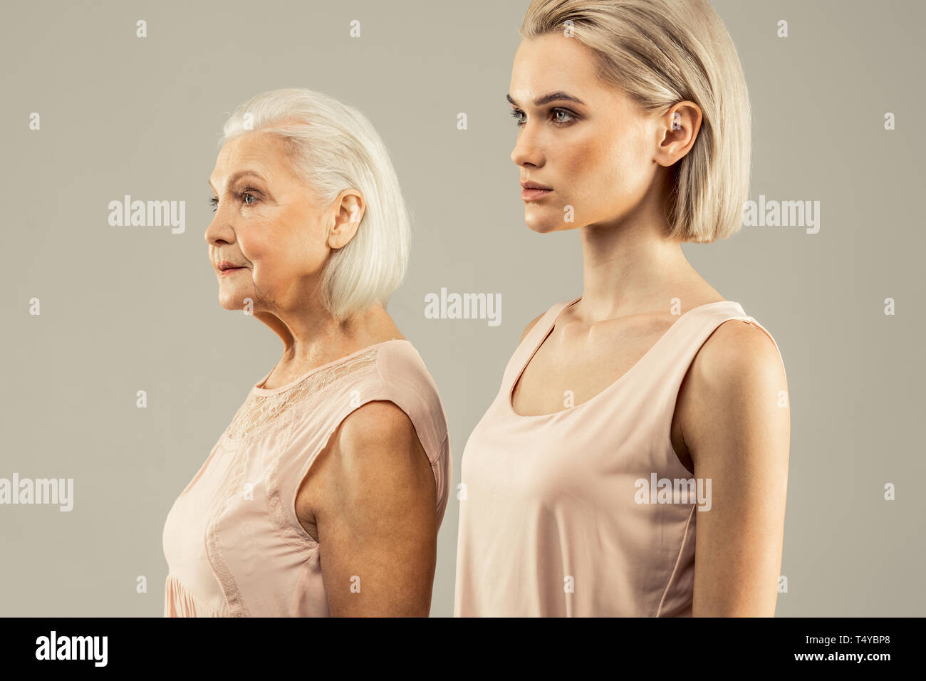 Nice pleasant good looking women standing together Stock Photo - Alamy