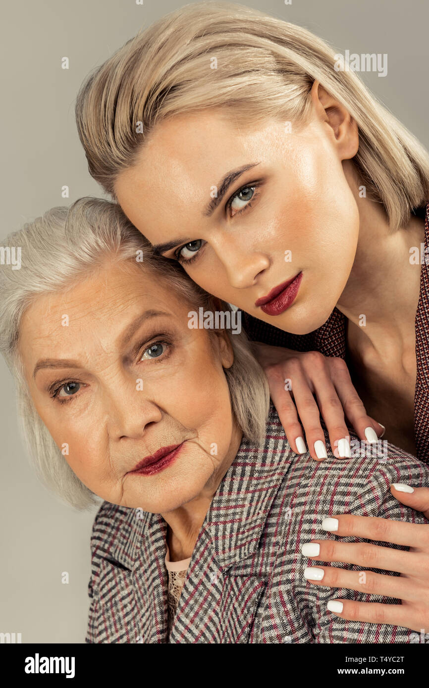 Faces of pleasant nice mother and daughter Stock Photo - Alamy
