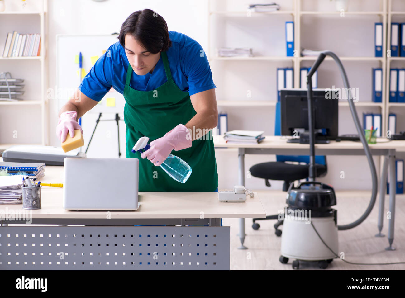 Male handsome professional cleaner working in the office Stock Photo ...