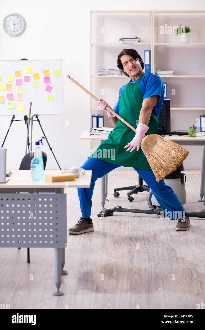 Male handsome professional cleaner working in the office Stock Photo ...