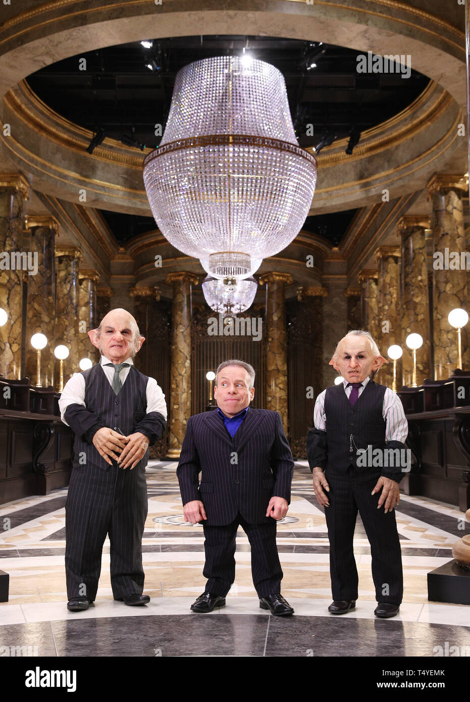 Warwick Davis with James and Oliver Phelps attend the reveal of the ...