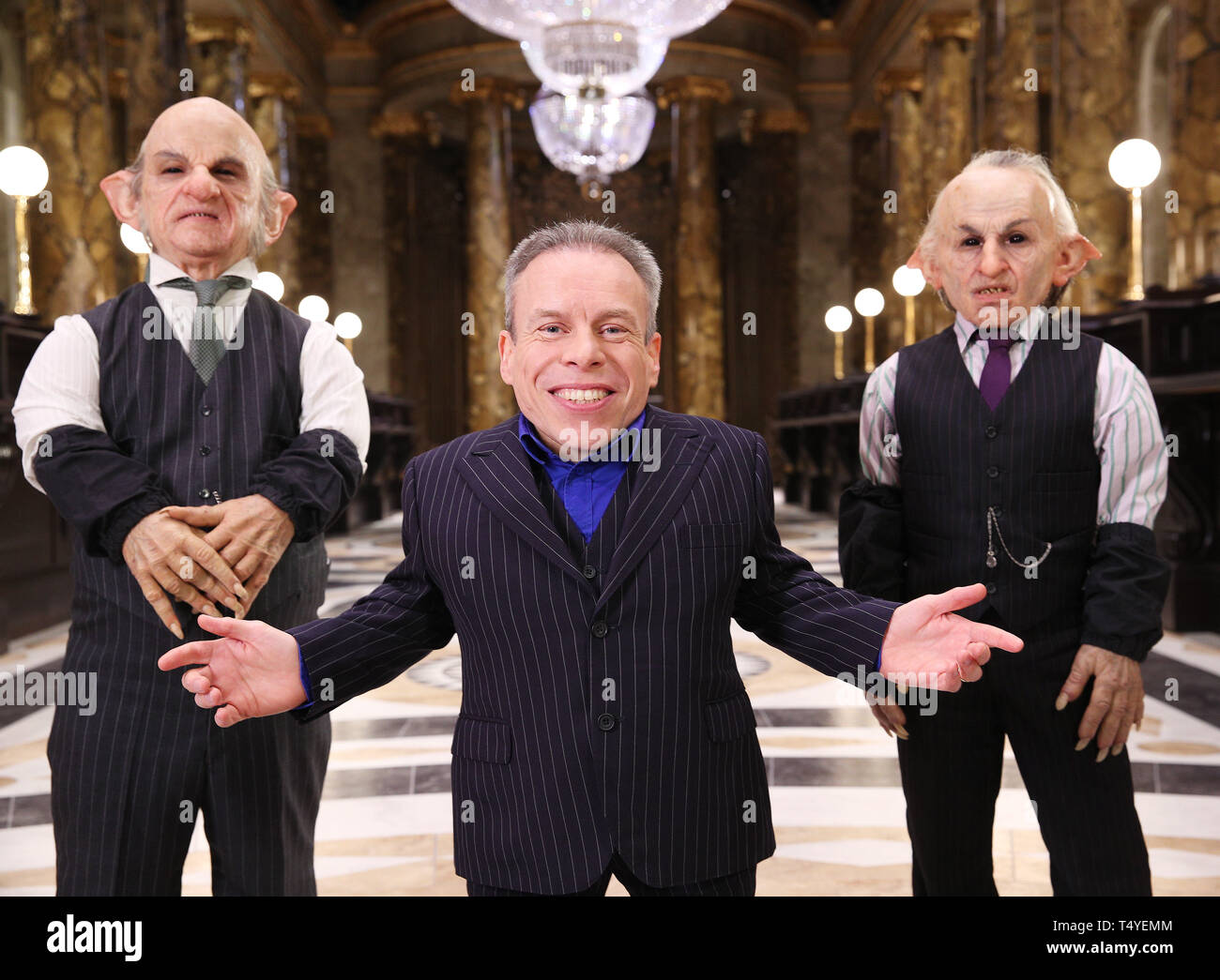 Warwick Davis with James and Oliver Phelps attend the reveal of the ...