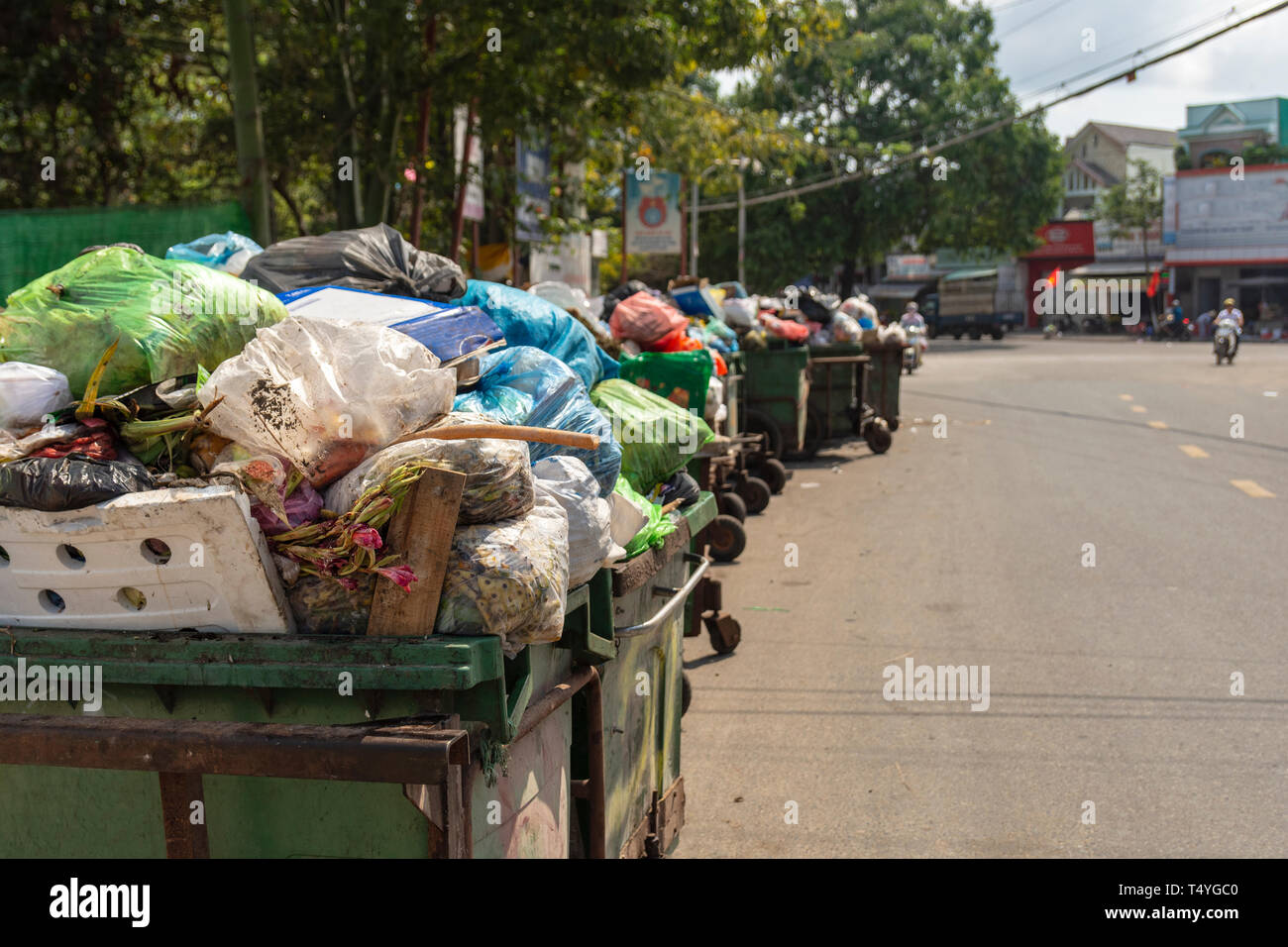 Overfilled garbabe containers on street in Duong Dong city on Phu Quoc ...