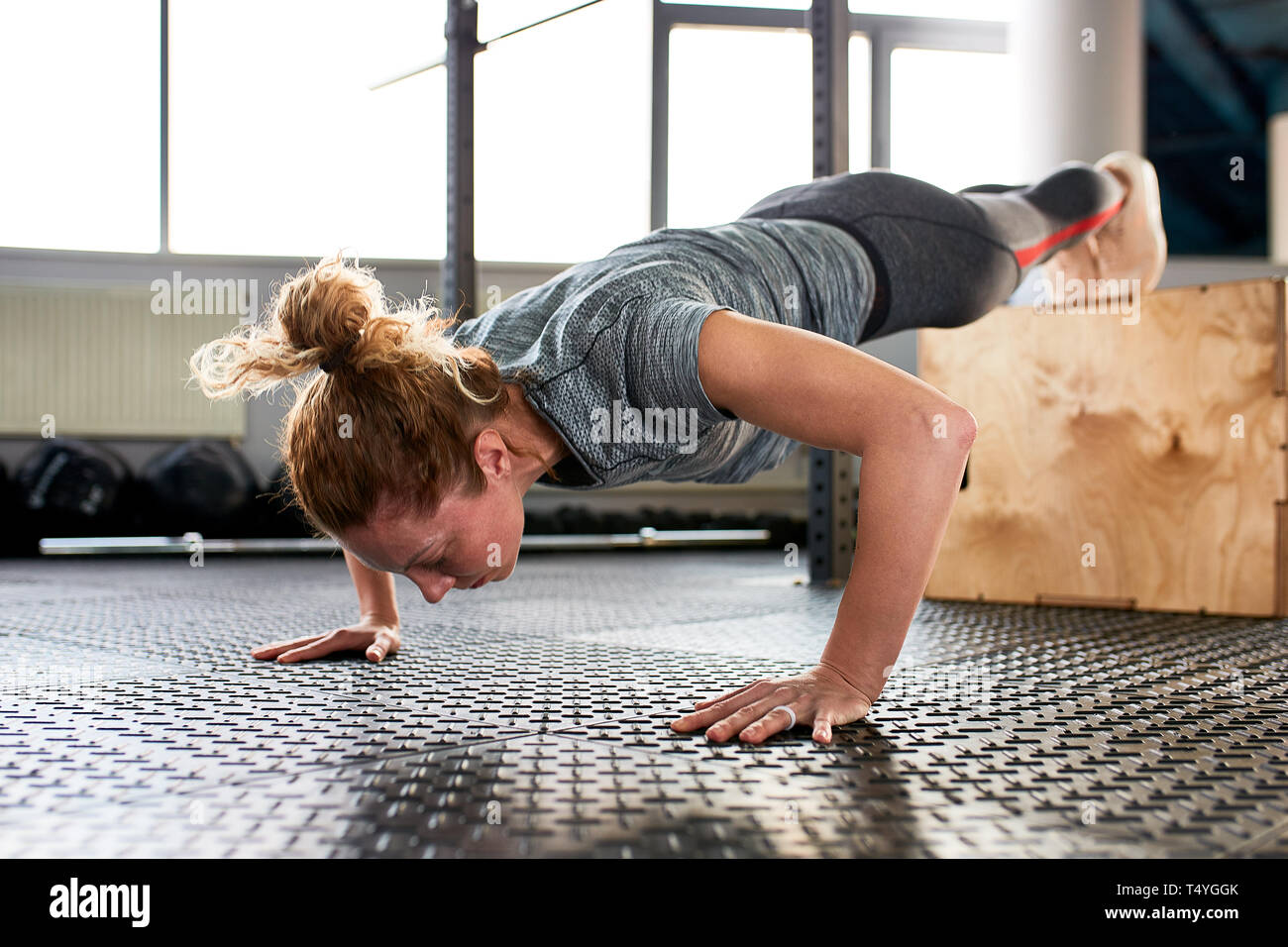 Athletic attractive woman wrung out in gym. Training concept, sport ...