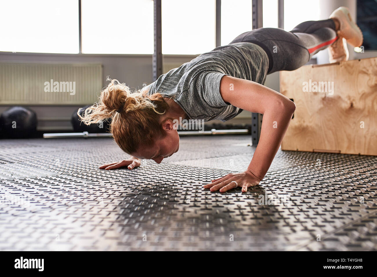 Athletic attractive woman wrung out in gym. Training concept, sport ...