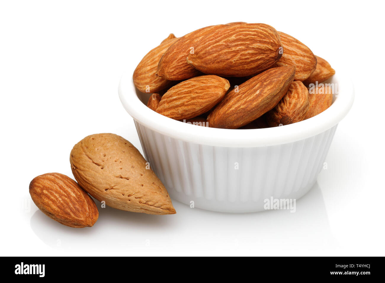 Almonds in the bowl isolated on white background Stock Photo - Alamy