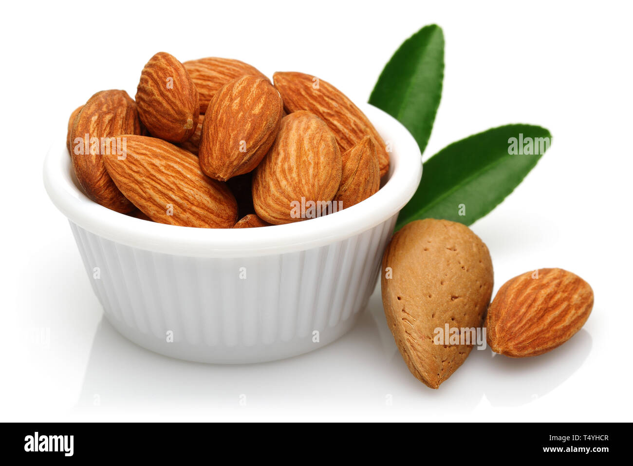 Almonds in the bowl isolated on white background Stock Photo - Alamy