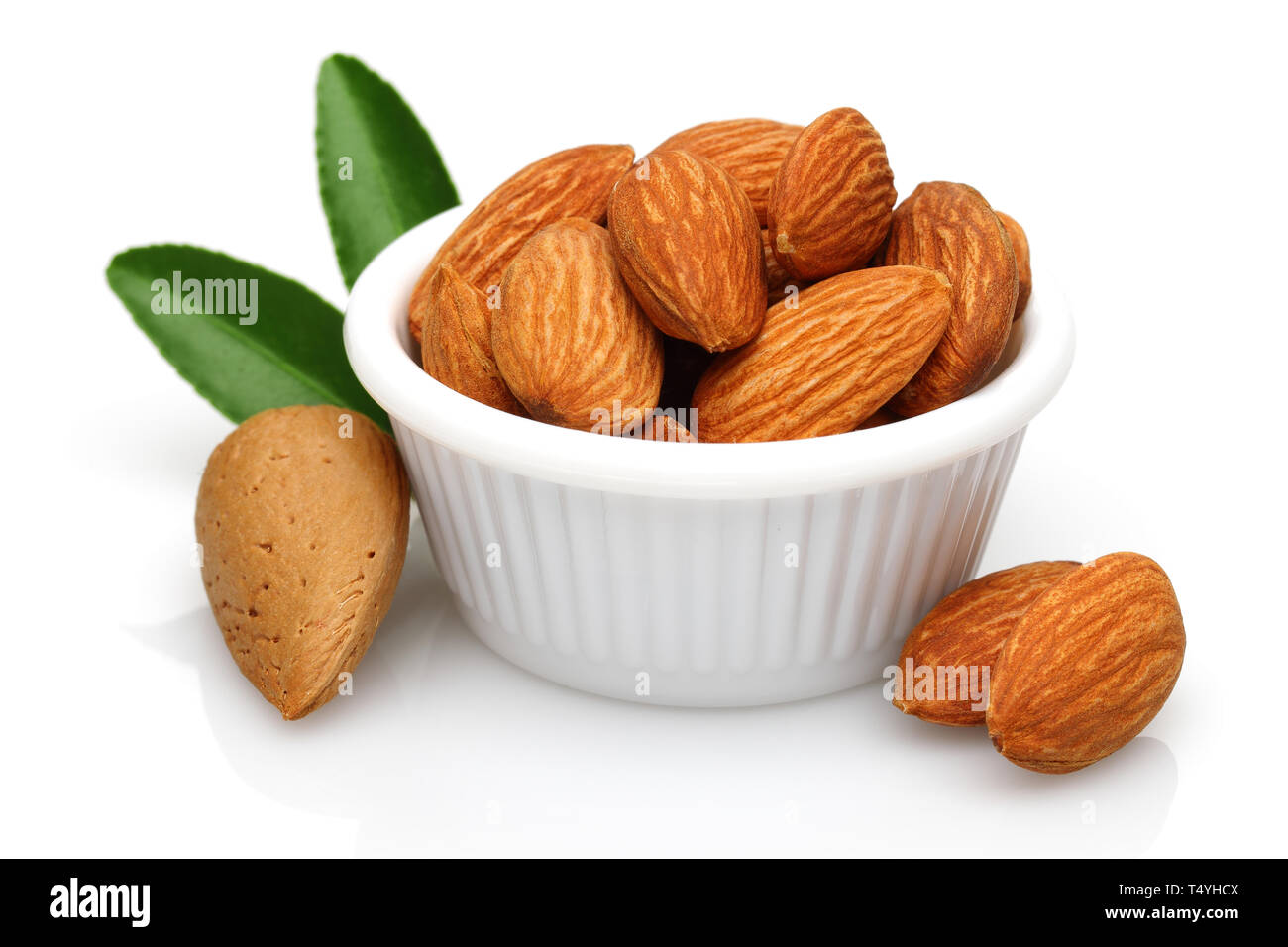 Almonds in the bowl isolated on white background Stock Photo - Alamy