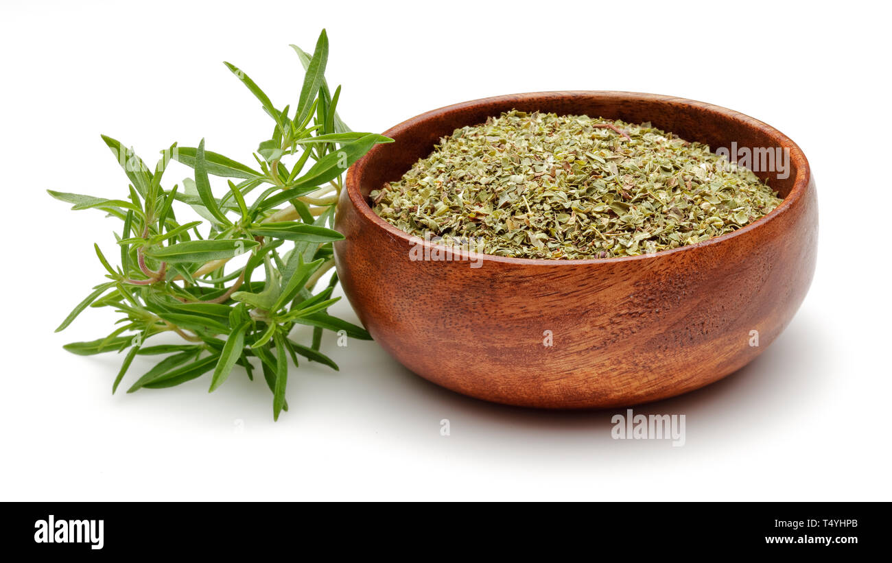 Fresh thyme and dried thyme in wooden bowl isolated on white background ...