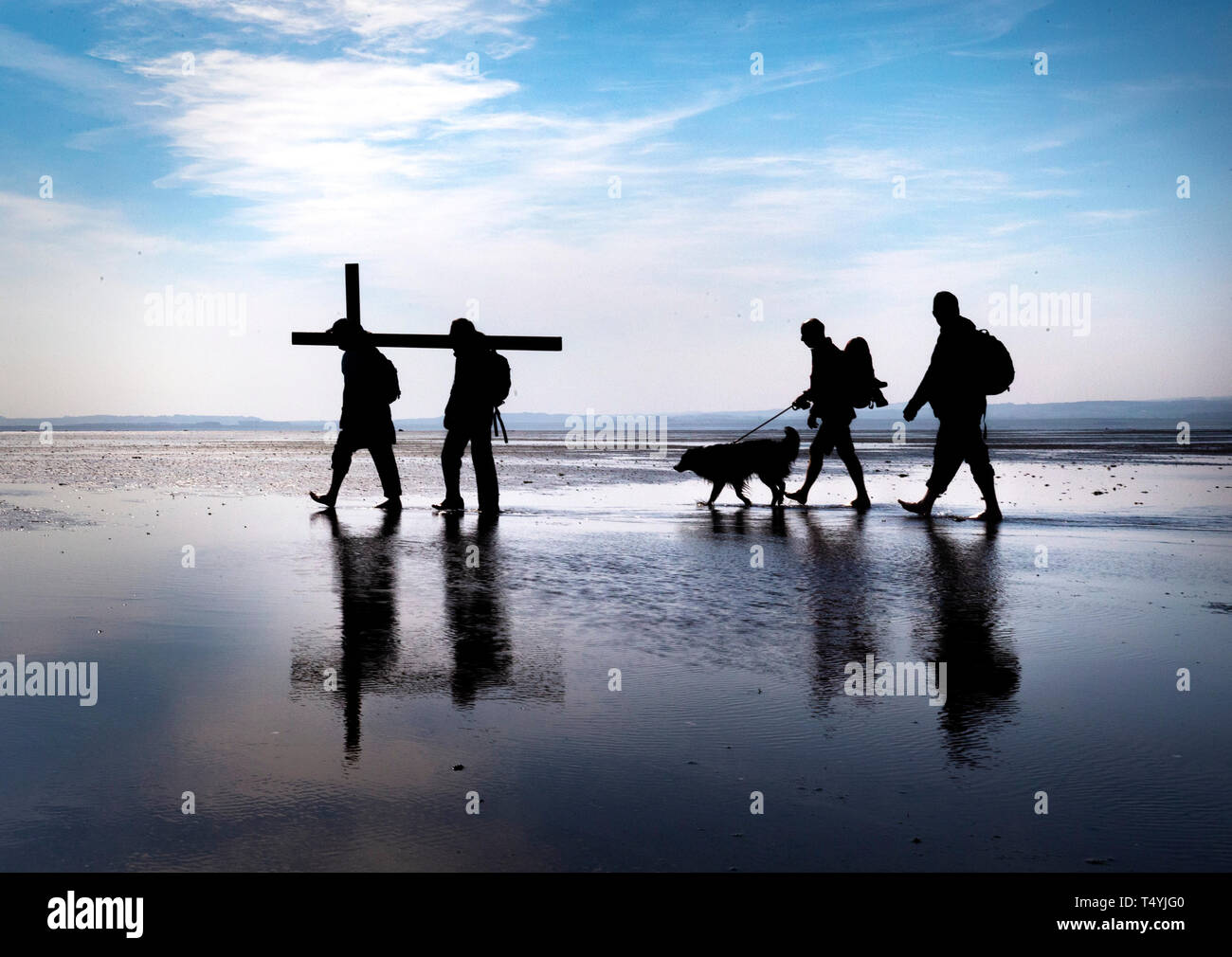 Pilgrims carrying crosses to the Holy Island of Lindisfarne in ...