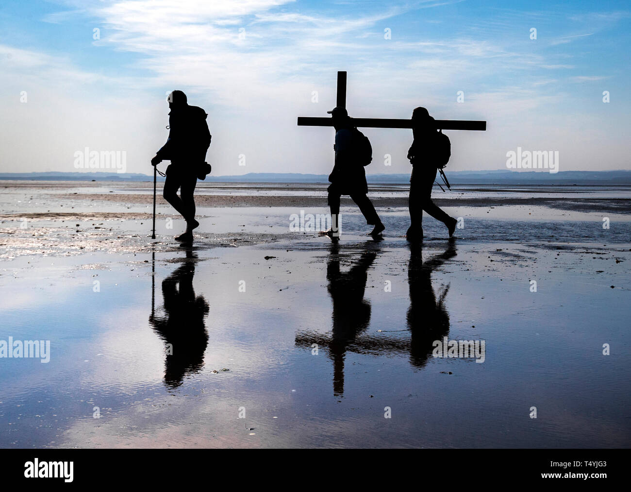Pilgrims carrying crosses to the Holy Island of Lindisfarne in ...