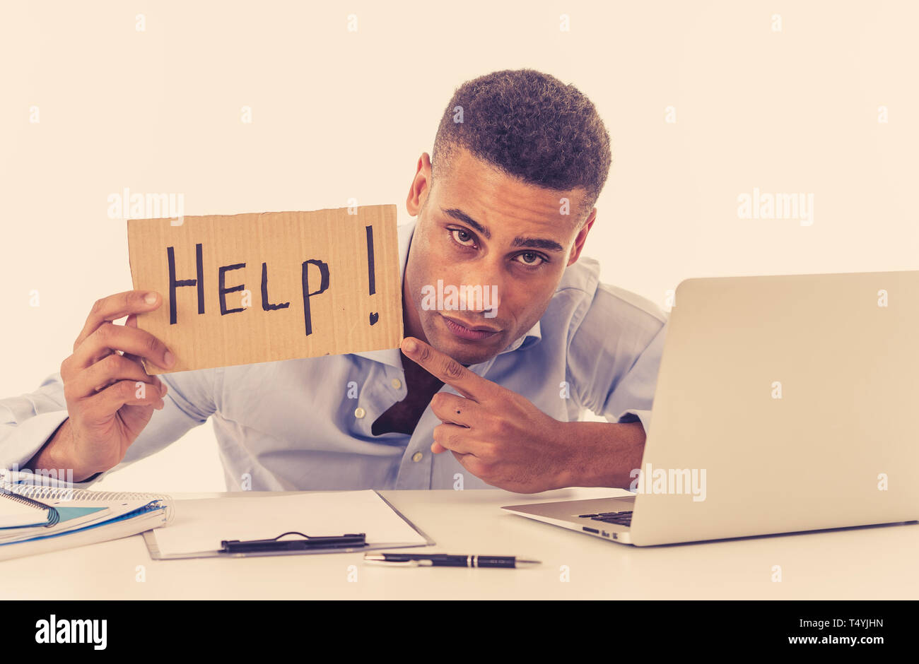 Desperate young attractive businessman working on computer laptop ...