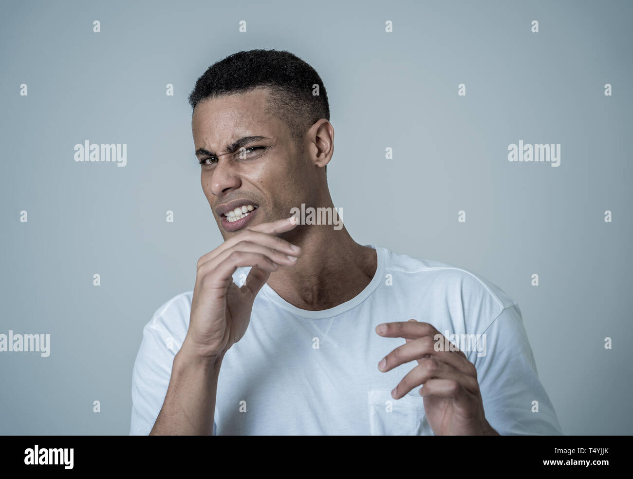 Portrait of young african american man feeling scared and shocked ...