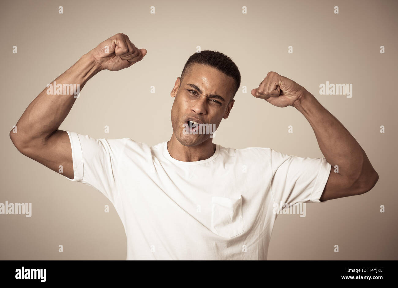 Young strong handsome african american man showing arms muscles smiling ...