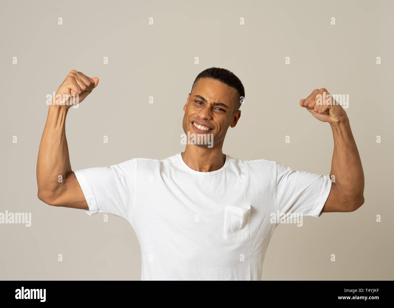Young strong handsome african american man showing arms muscles smiling ...