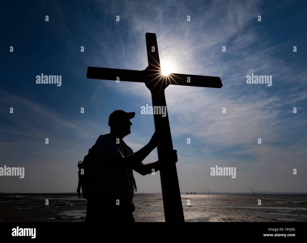 Pilgrims carrying crosses to the Holy Island of Lindisfarne in ...