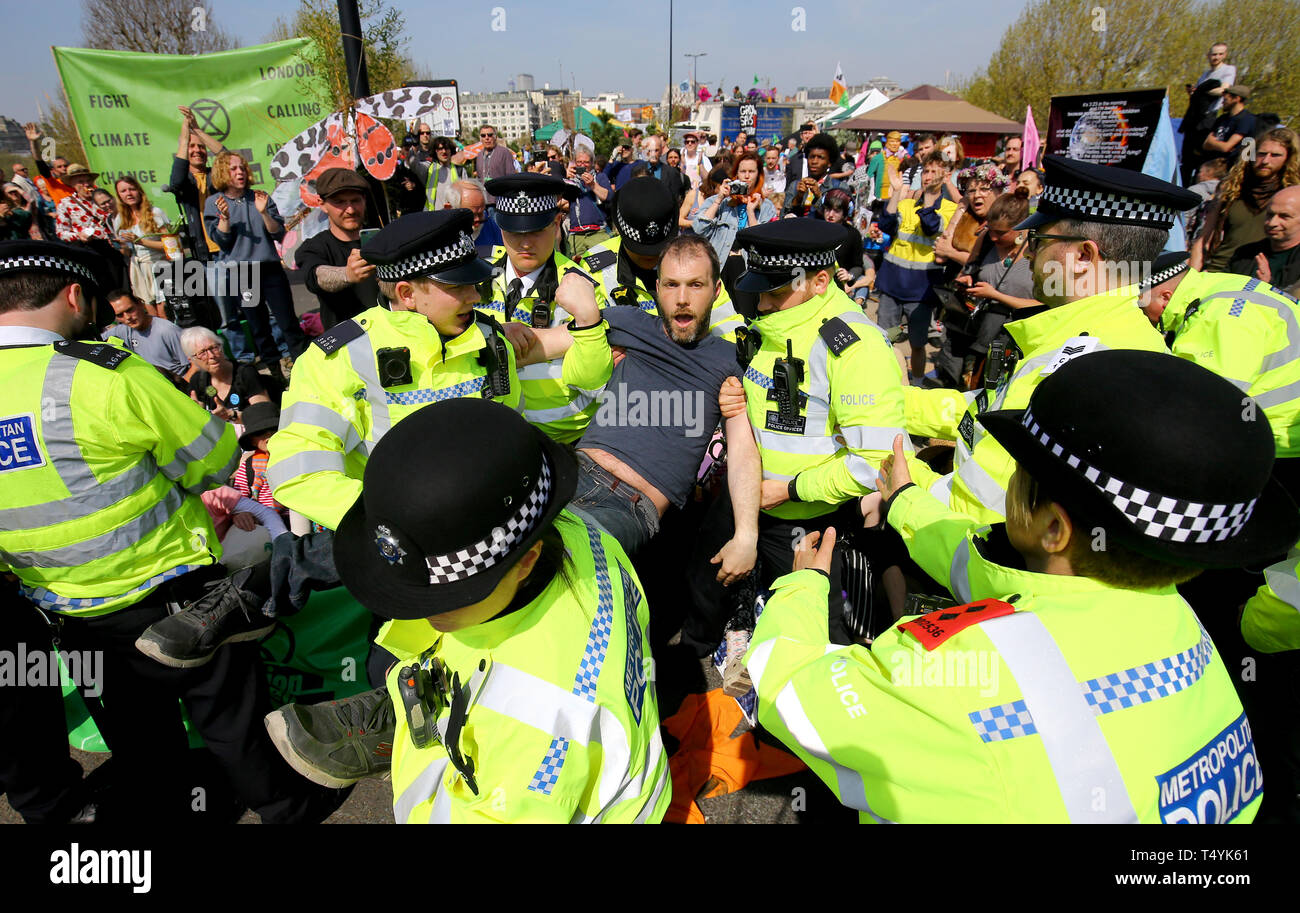 An Extinction Rebellion demonstrator is carried away by police on ...