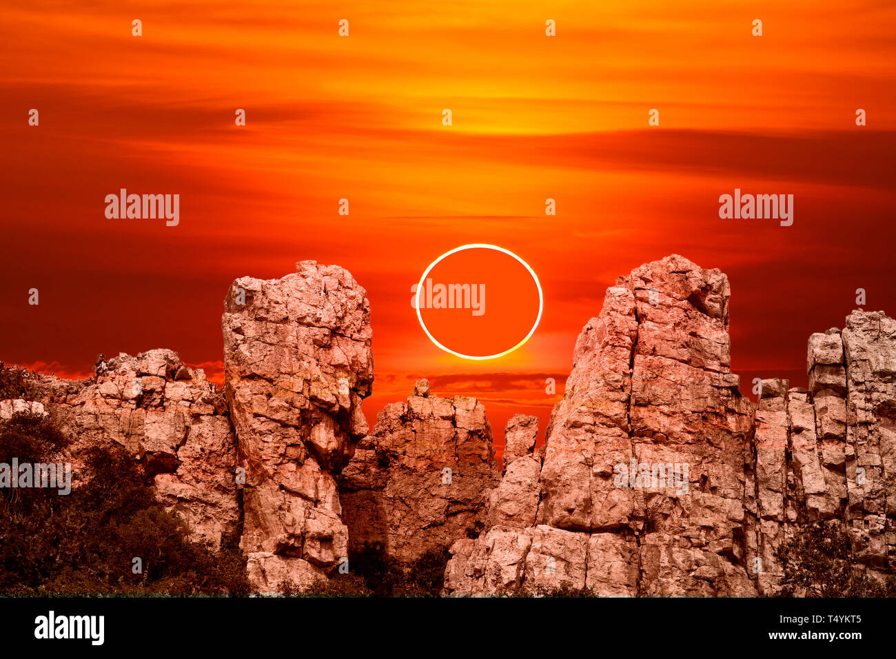 annular eclipse over stone on rock of cliff Stock Photo - Alamy