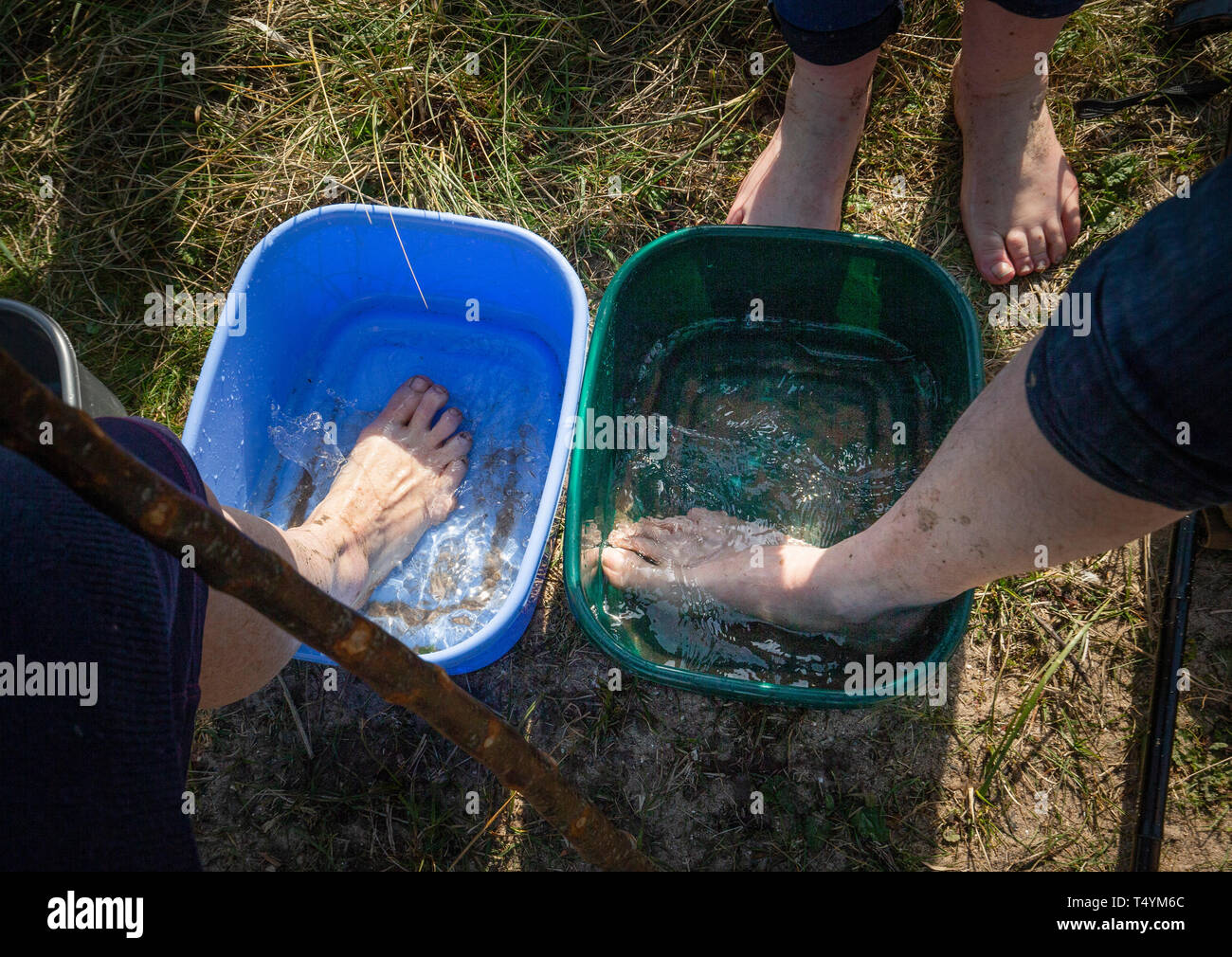 Pilgrims wash their feet after carrying crosses to the Holy Island of ...