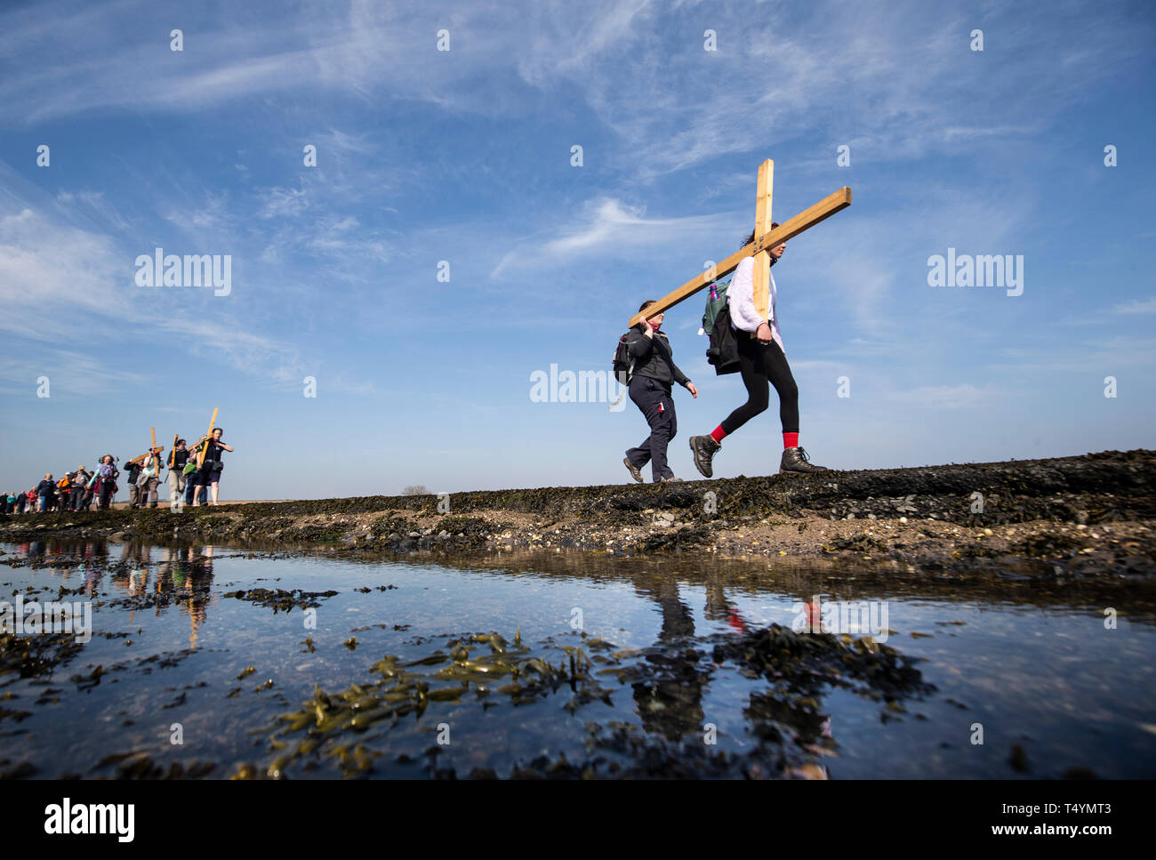 Pilgrims carrying crosses to the Holy Island of Lindisfarne in ...