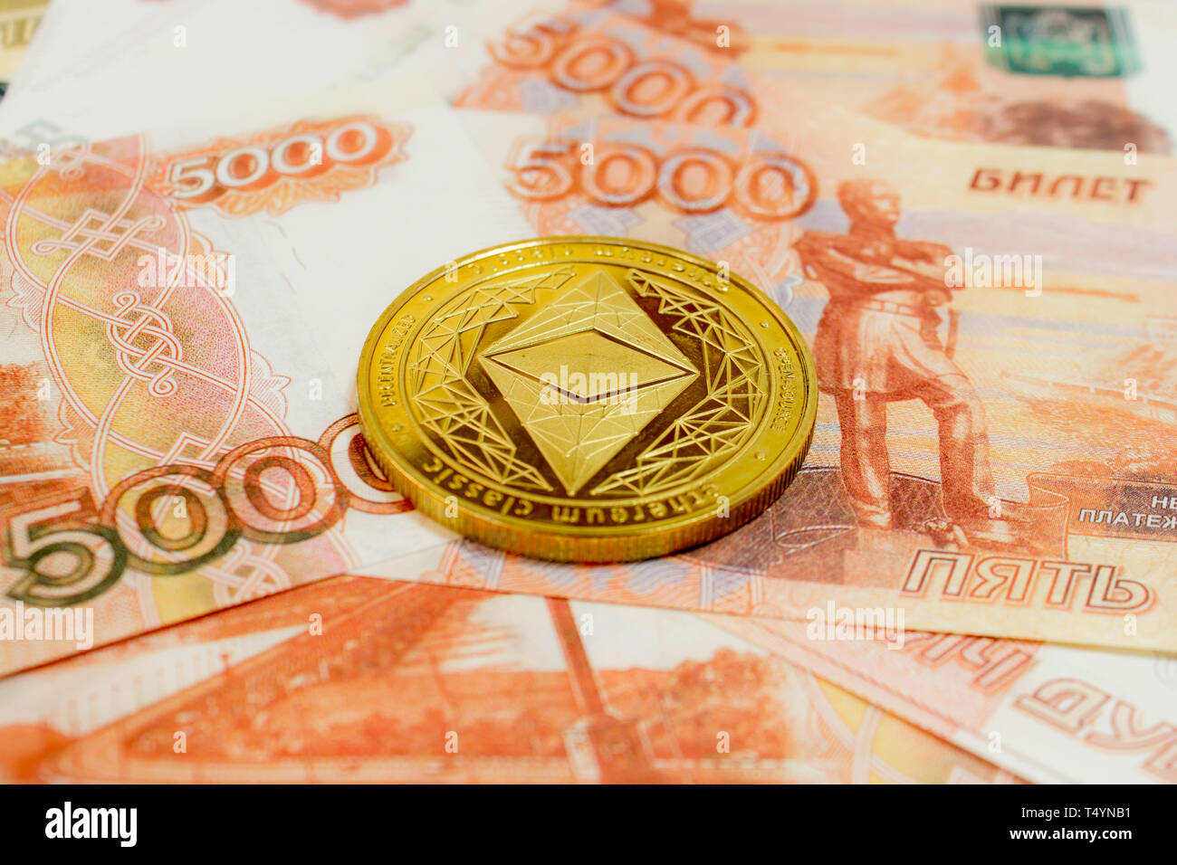 Golden Etherium coin close up on white background Stock Photo - Alamy
