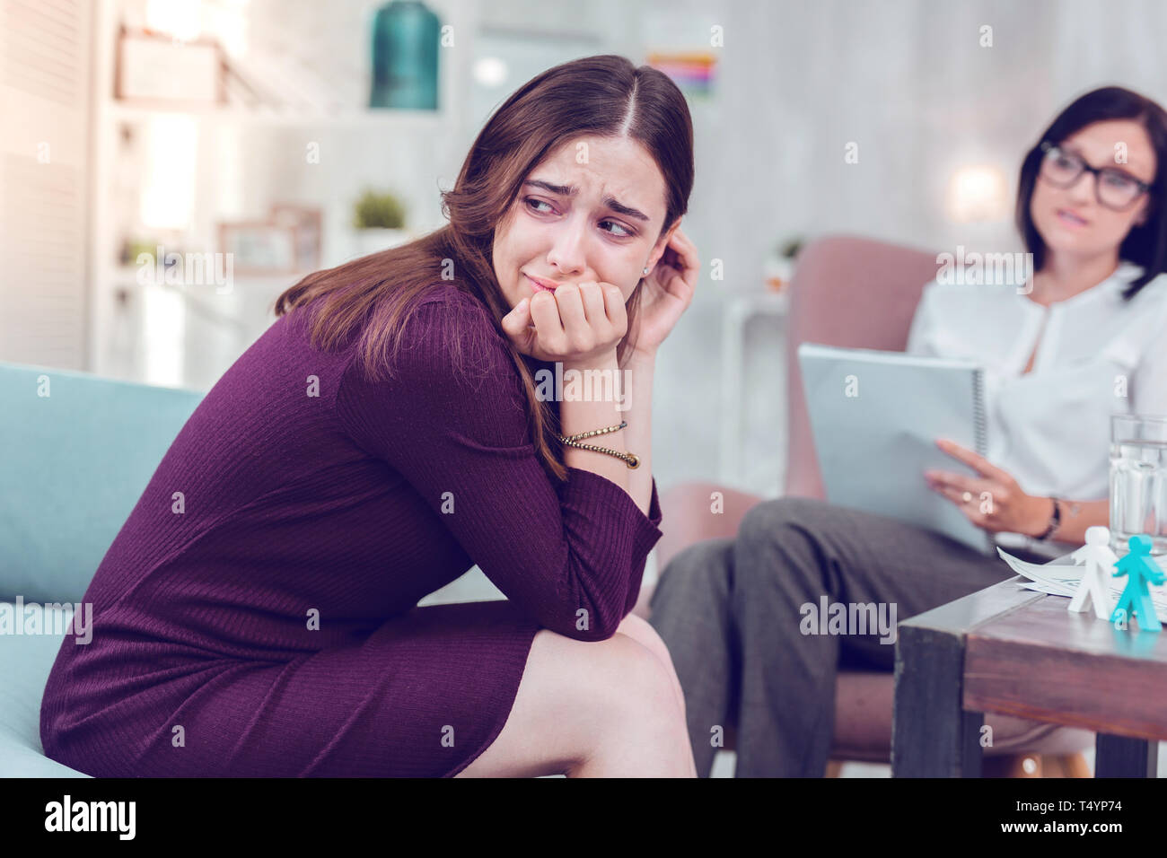 Sad sorrowful charming woman crying during a visit to phycologist Stock ...