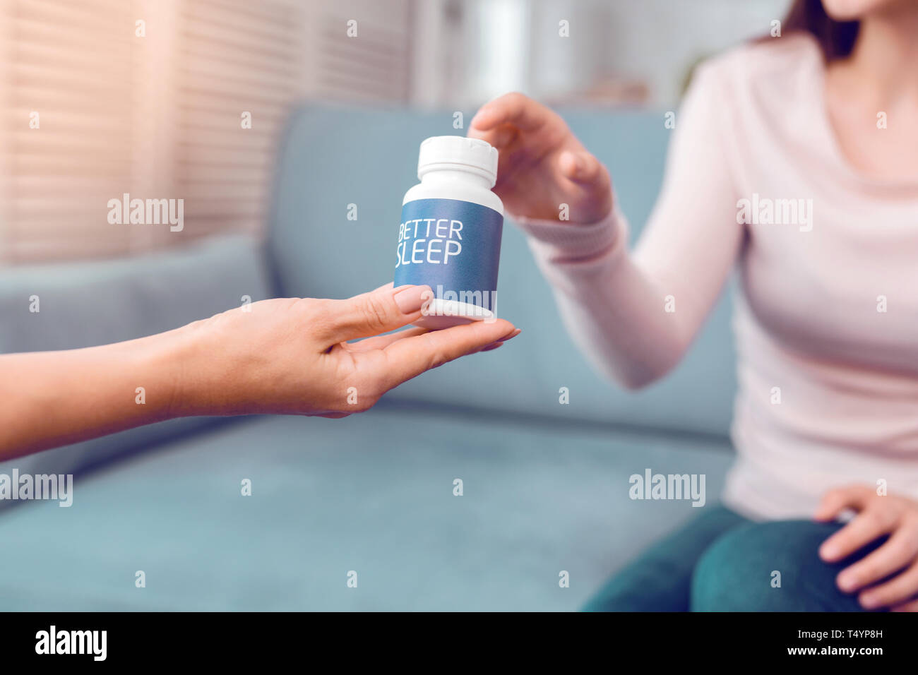 Close-up photo of the process of handing a bottle Stock Photo - Alamy