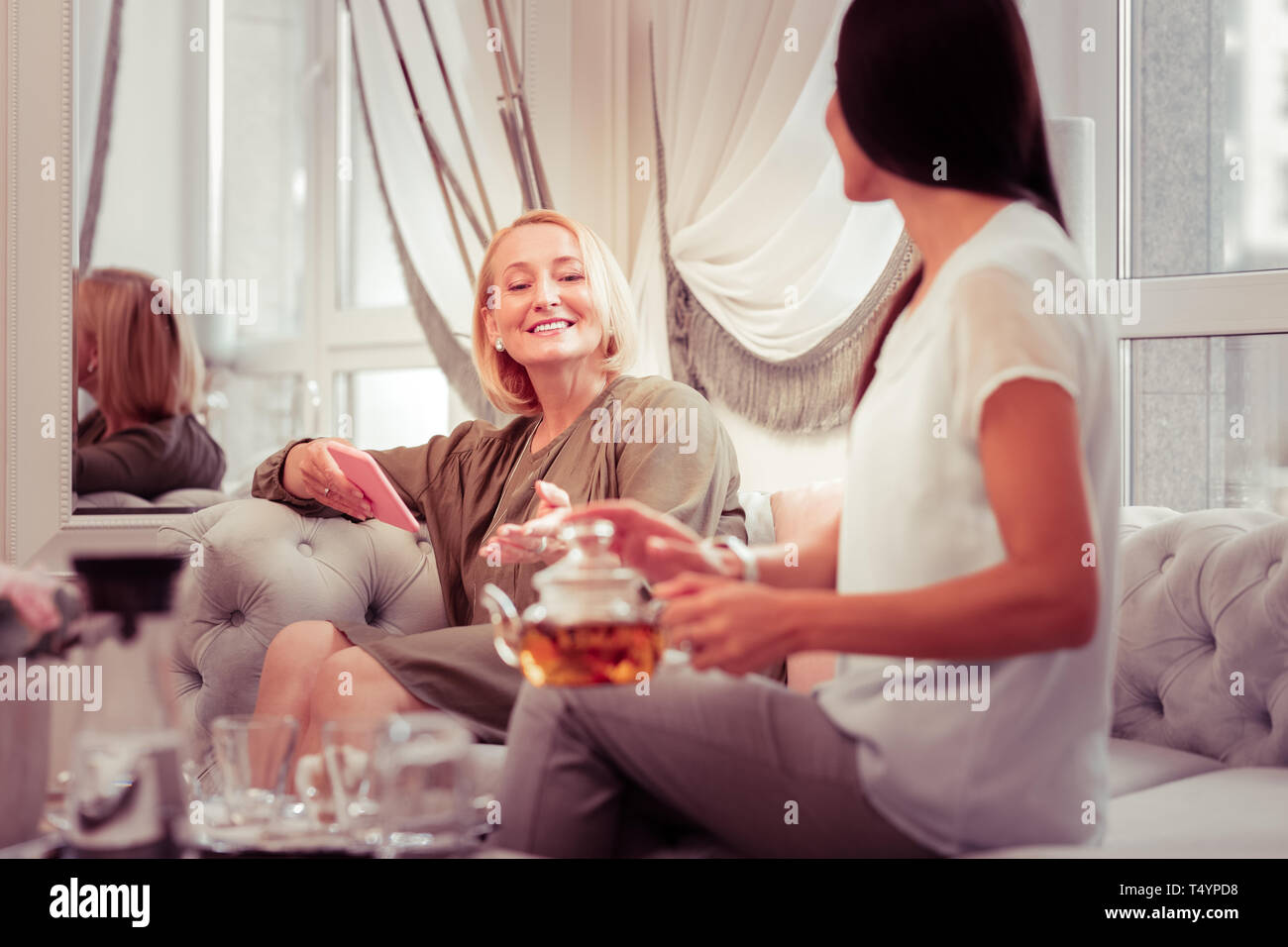 Joyful females going to drink tasty tea Stock Photo - Alamy