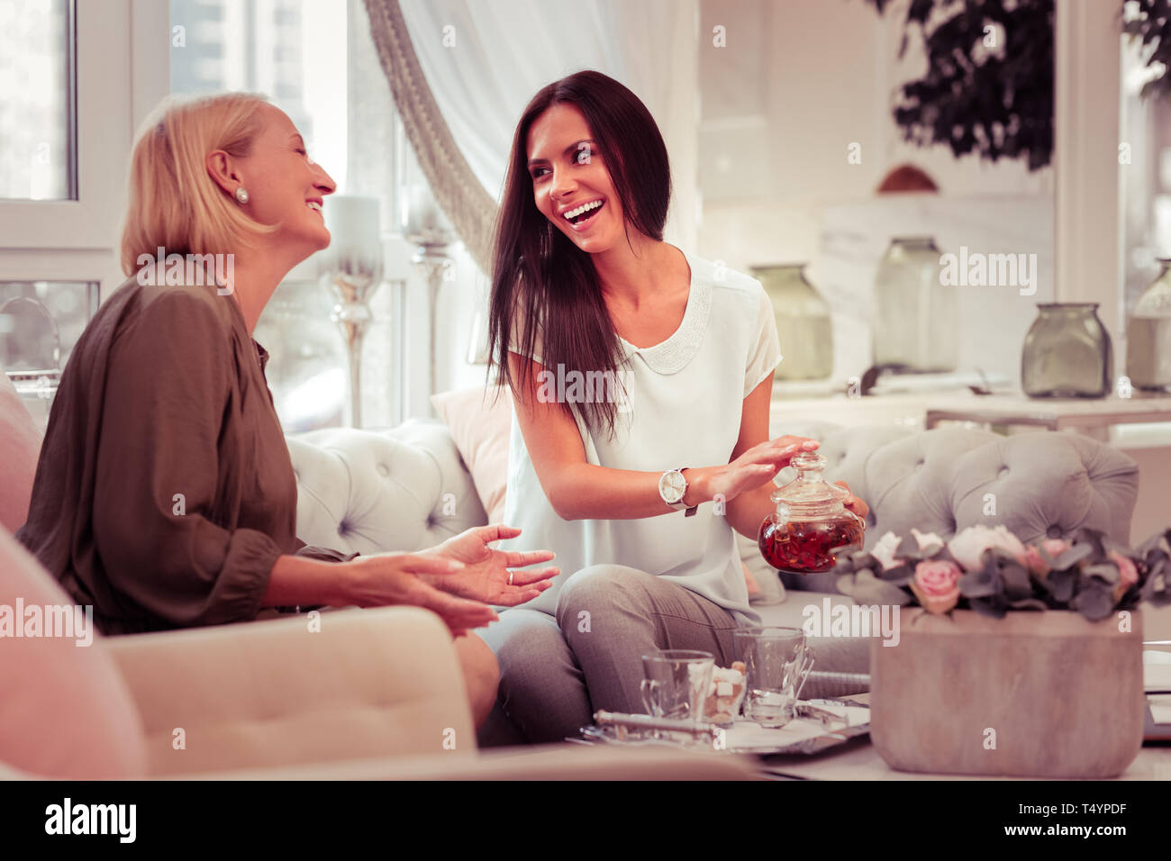 Kind blonde woman keeping smile on her face Stock Photo - Alamy