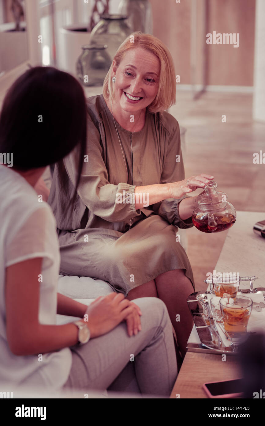 Two cups and pouring tea hi-res stock photography and images - Alamy