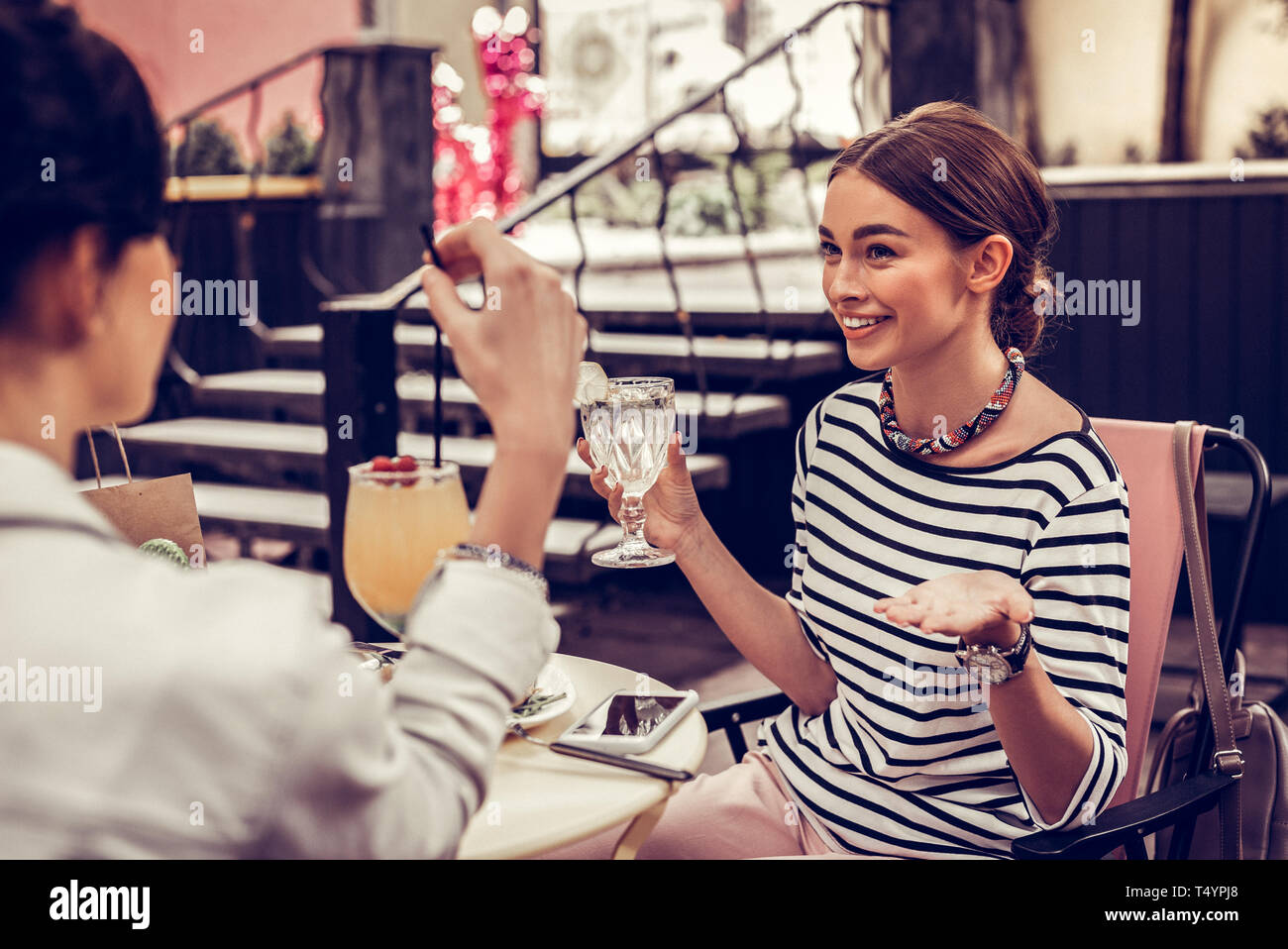Positive happy woman speaking with her friend Stock Photo - Alamy
