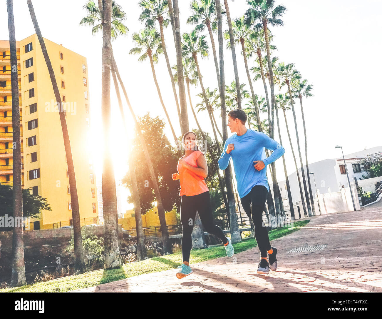 Healthy young couple jogging together at sunset time outdoor - People ...