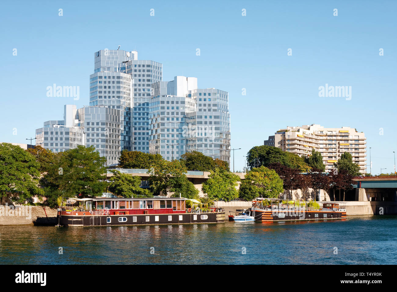 city scene, River Seine, boats docked, modern apartment buildings ...