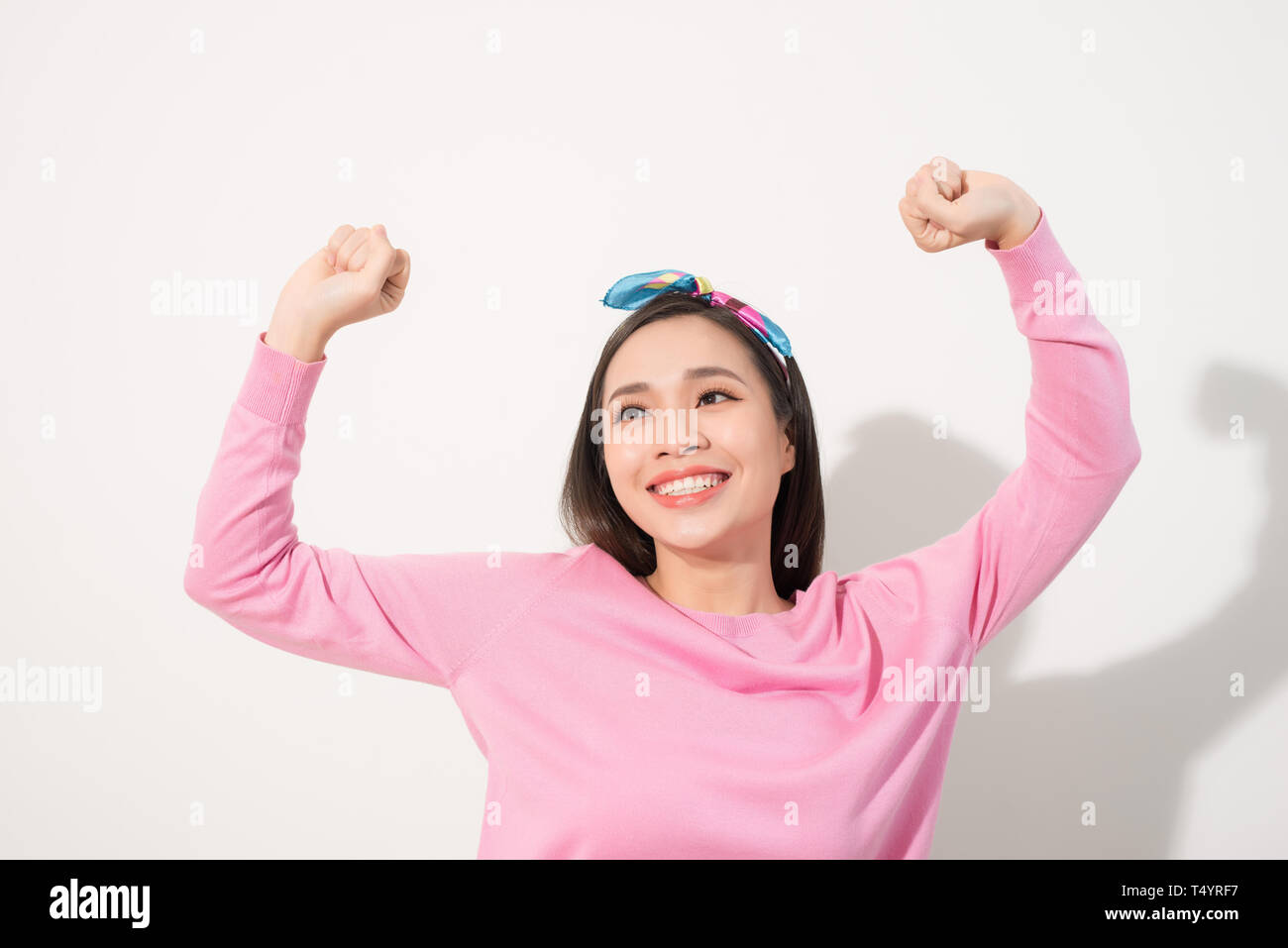 Attractive young woman relax and dance on copy space. Portrait of happy ...