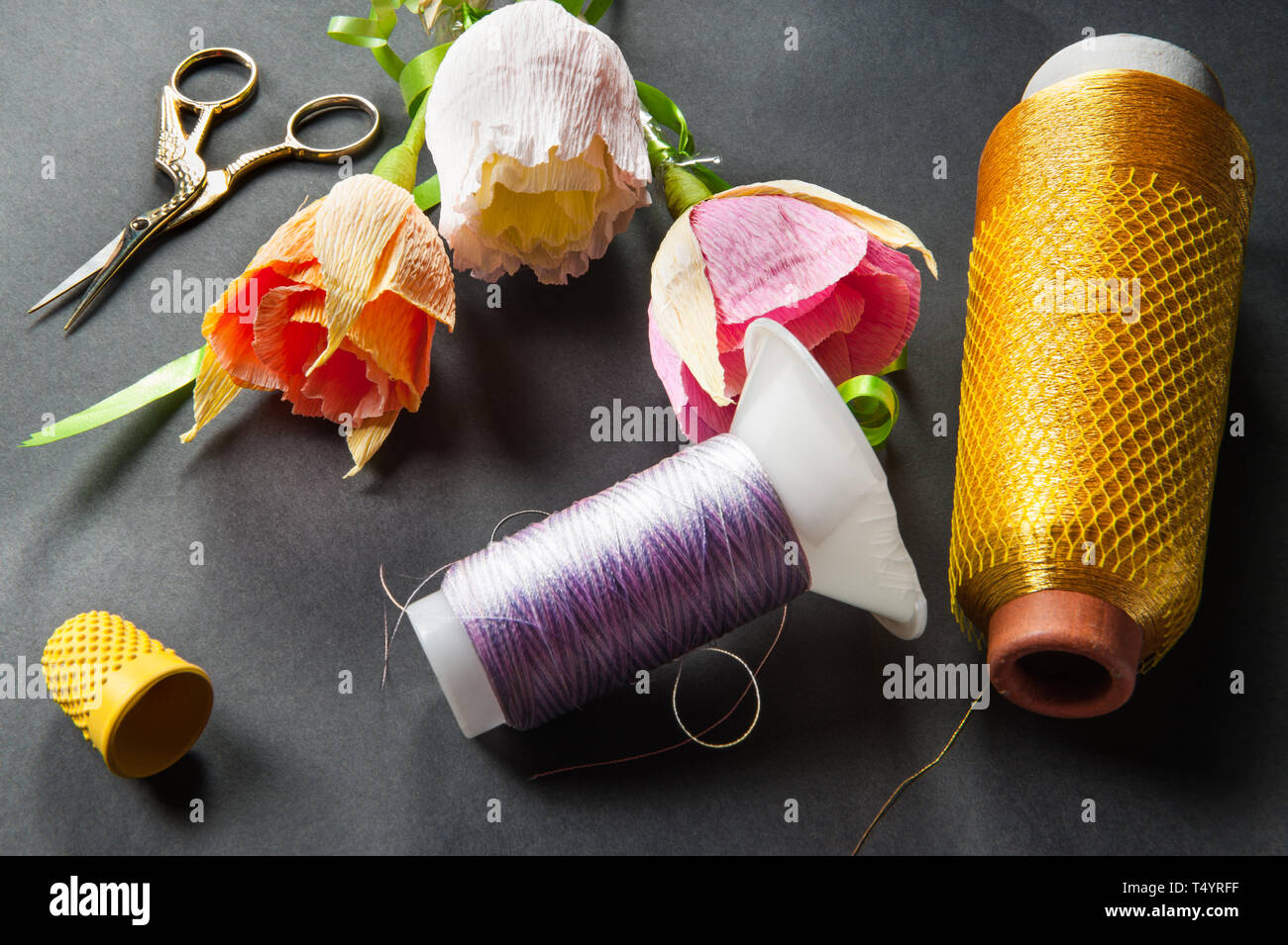 sewing tools thread with scissors and paper flowers Stock Photo - Alamy