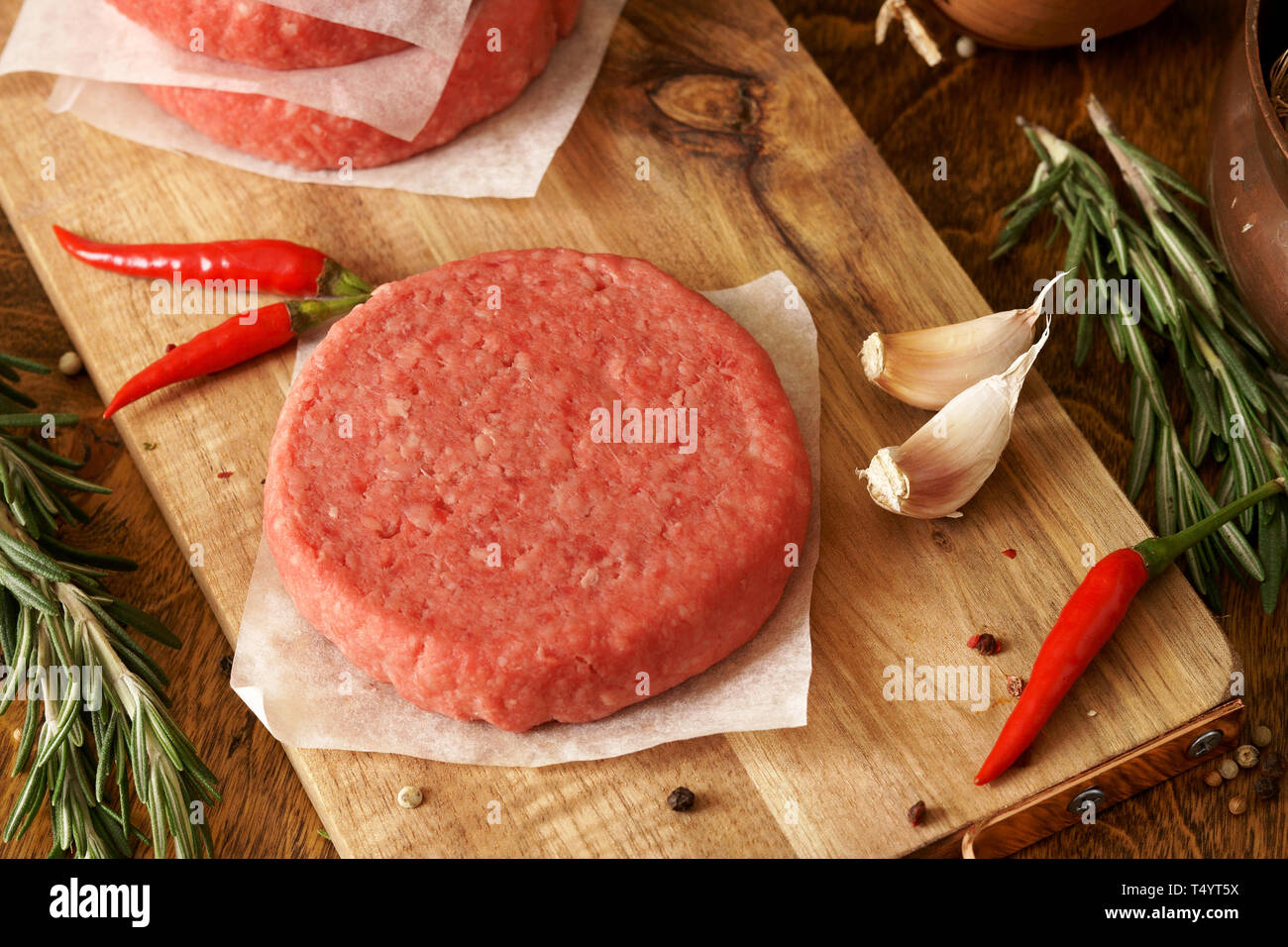 Raw beef burger, traditional barbecue, still life with vegetables and ...
