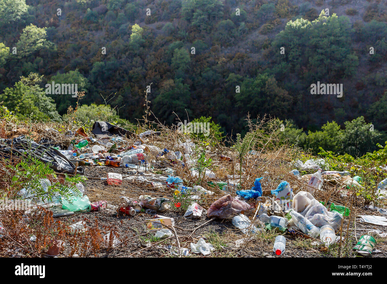 Plastic bottles, bags and other trash along the road. Trash at roadside ...