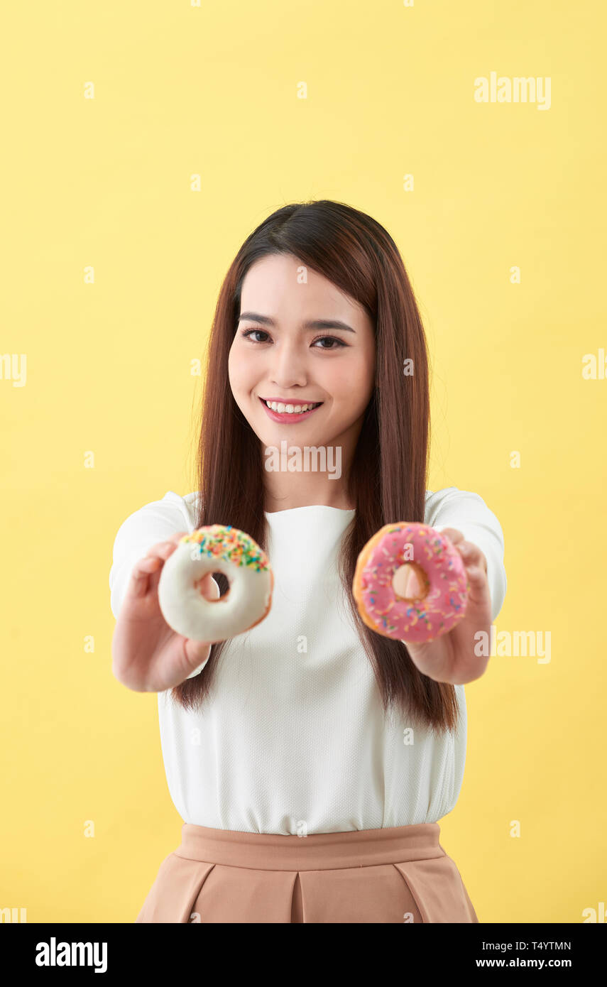 Beauty fashion model girl taking sweets and colorful donuts Stock Photo ...