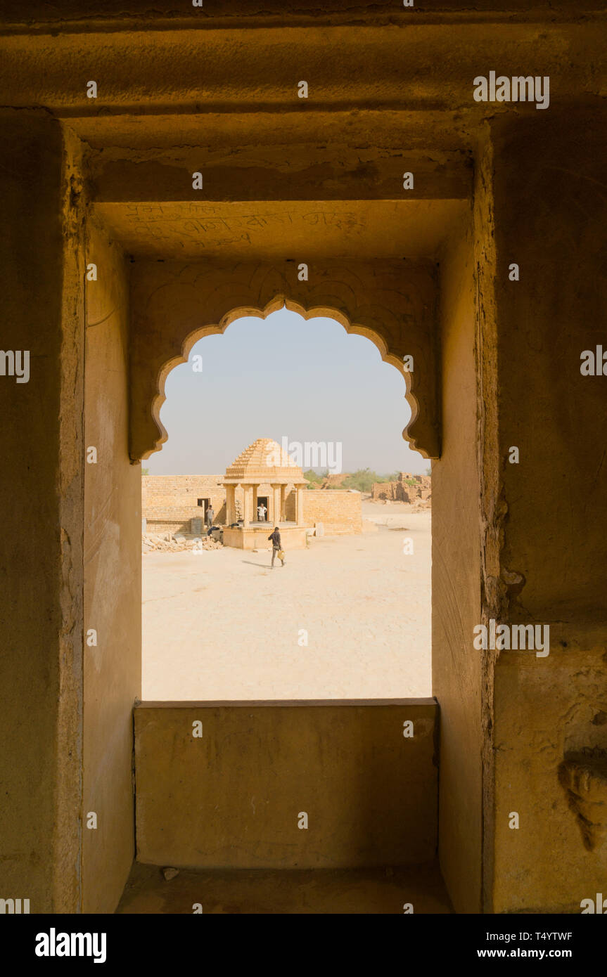 Looking out an arched stone window of rajasthani design onto the ...