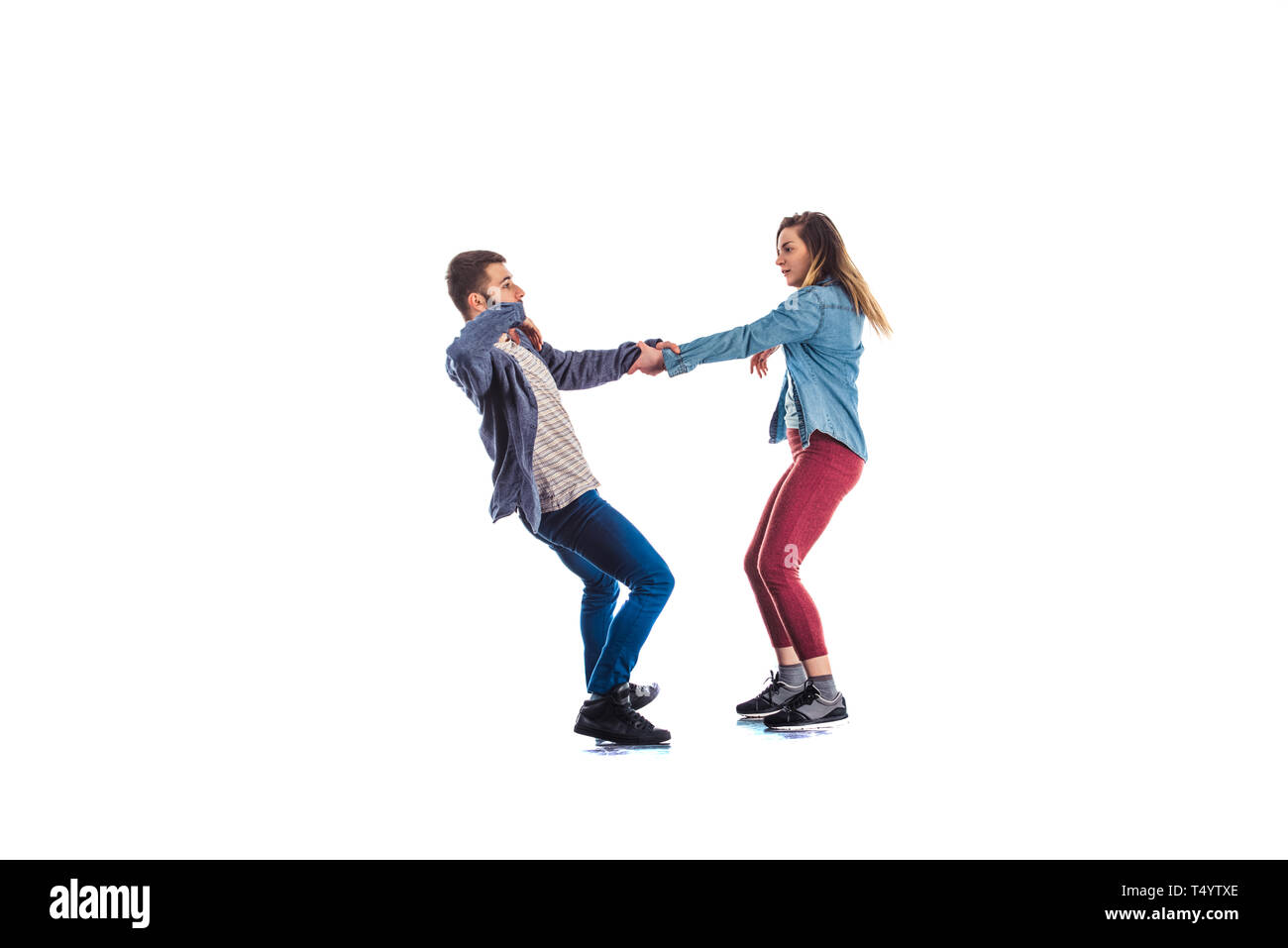 Young couple showing dance moves on white background Stock Photo - Alamy