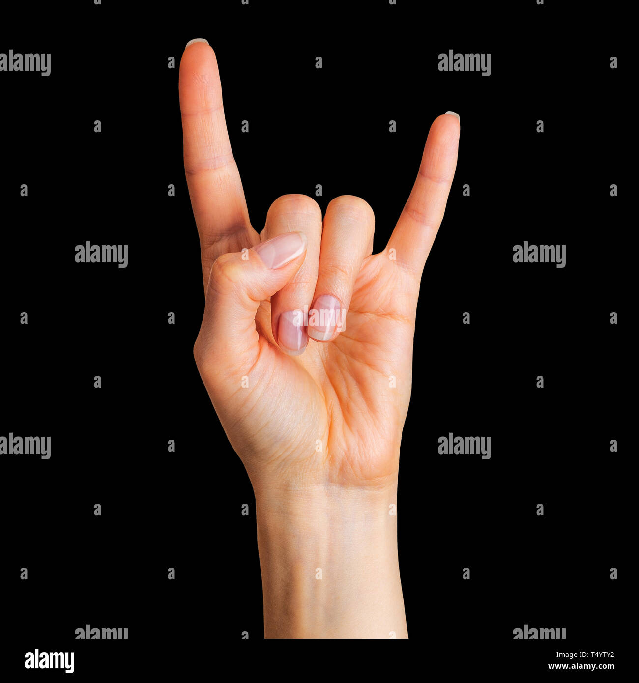 Female hand showing rock n roll sign or giving the devil horns gesture ...
