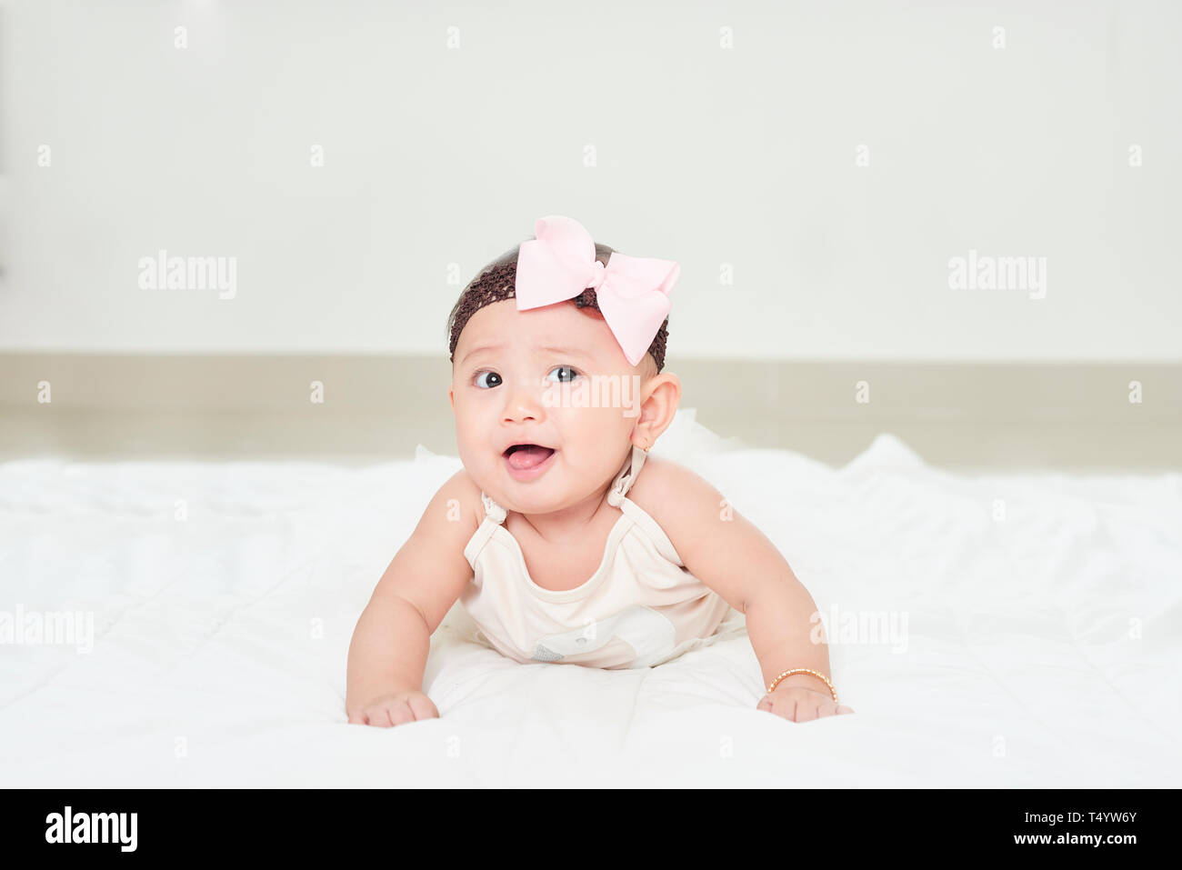 Baby girl smiling on the floor isolated on white Stock Photo - Alamy