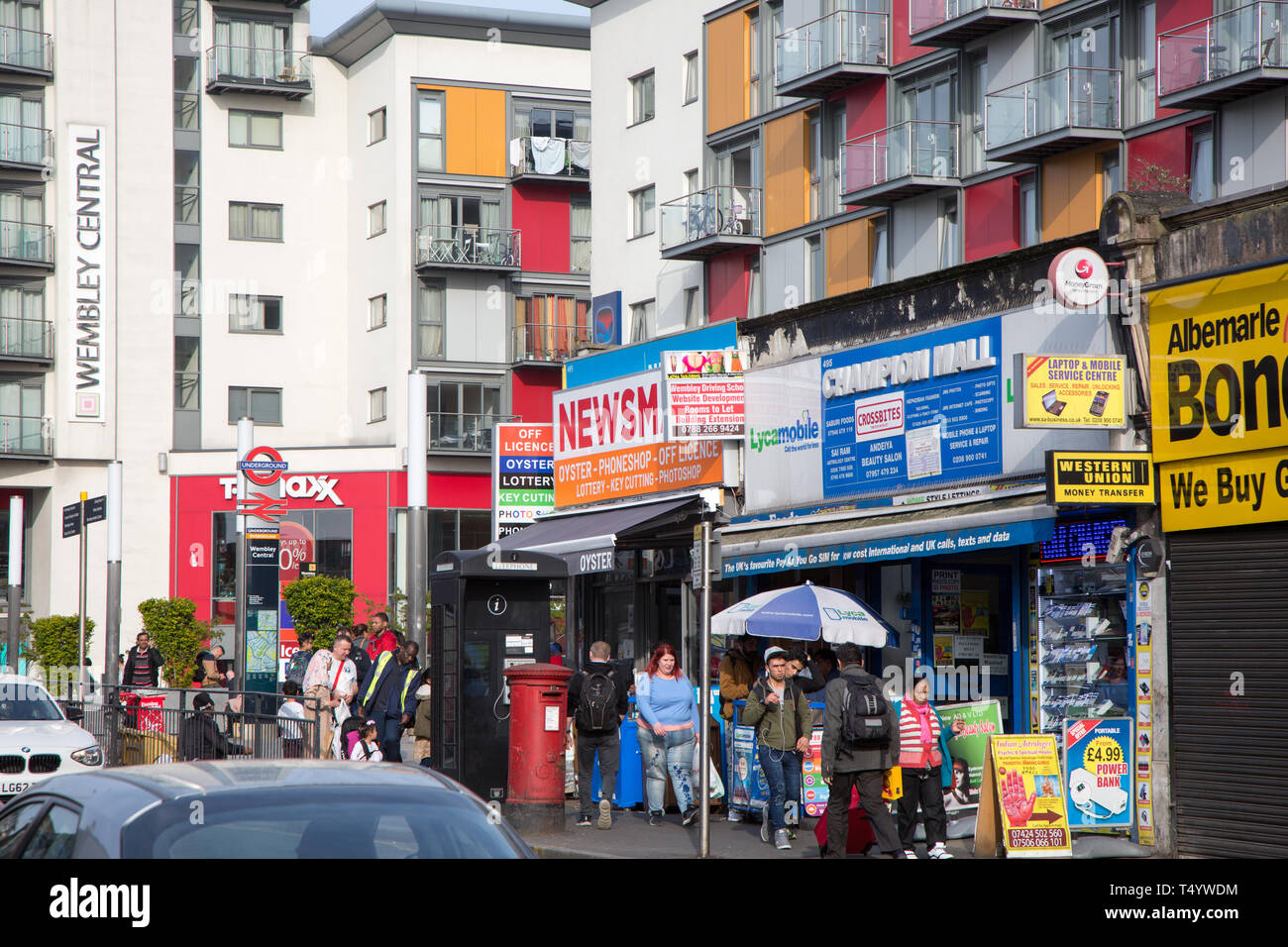 High Road Wembley. A row of shops and a modern housing project with ...